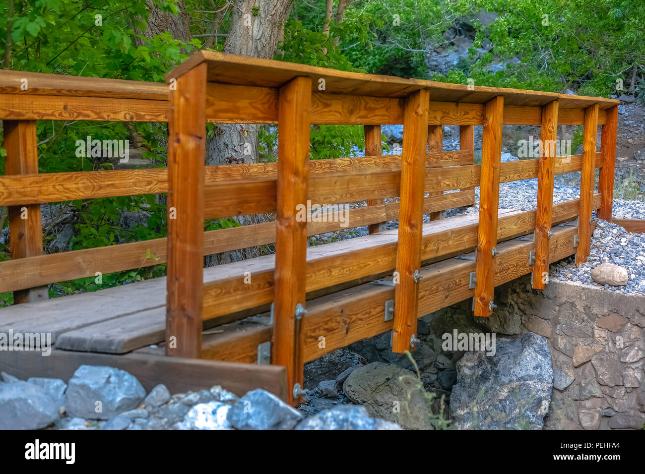 Wooden bridge over a rocky stream Stock Photo - Alamy