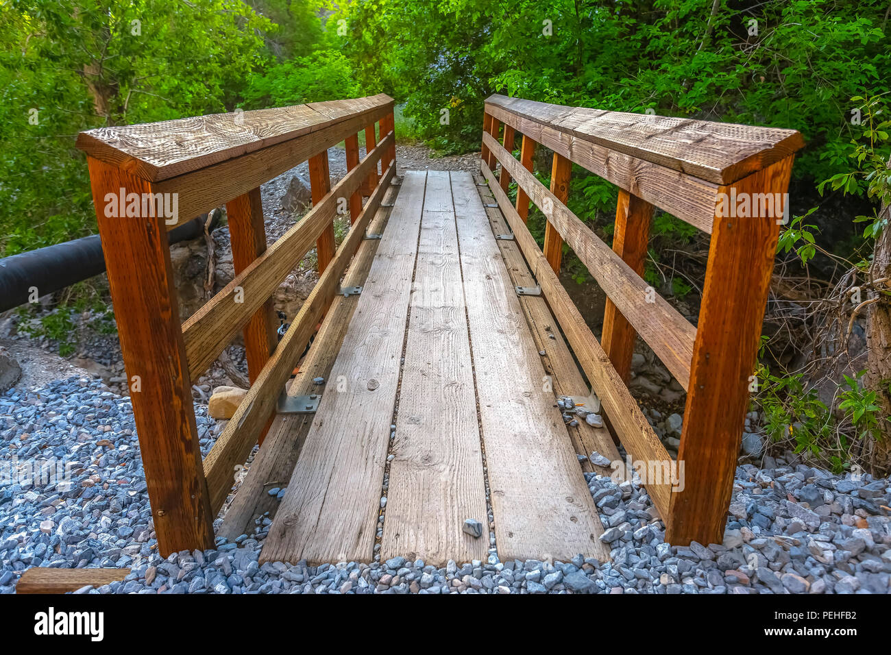 Wooden bridge straight on over stream Stock Photo - Alamy