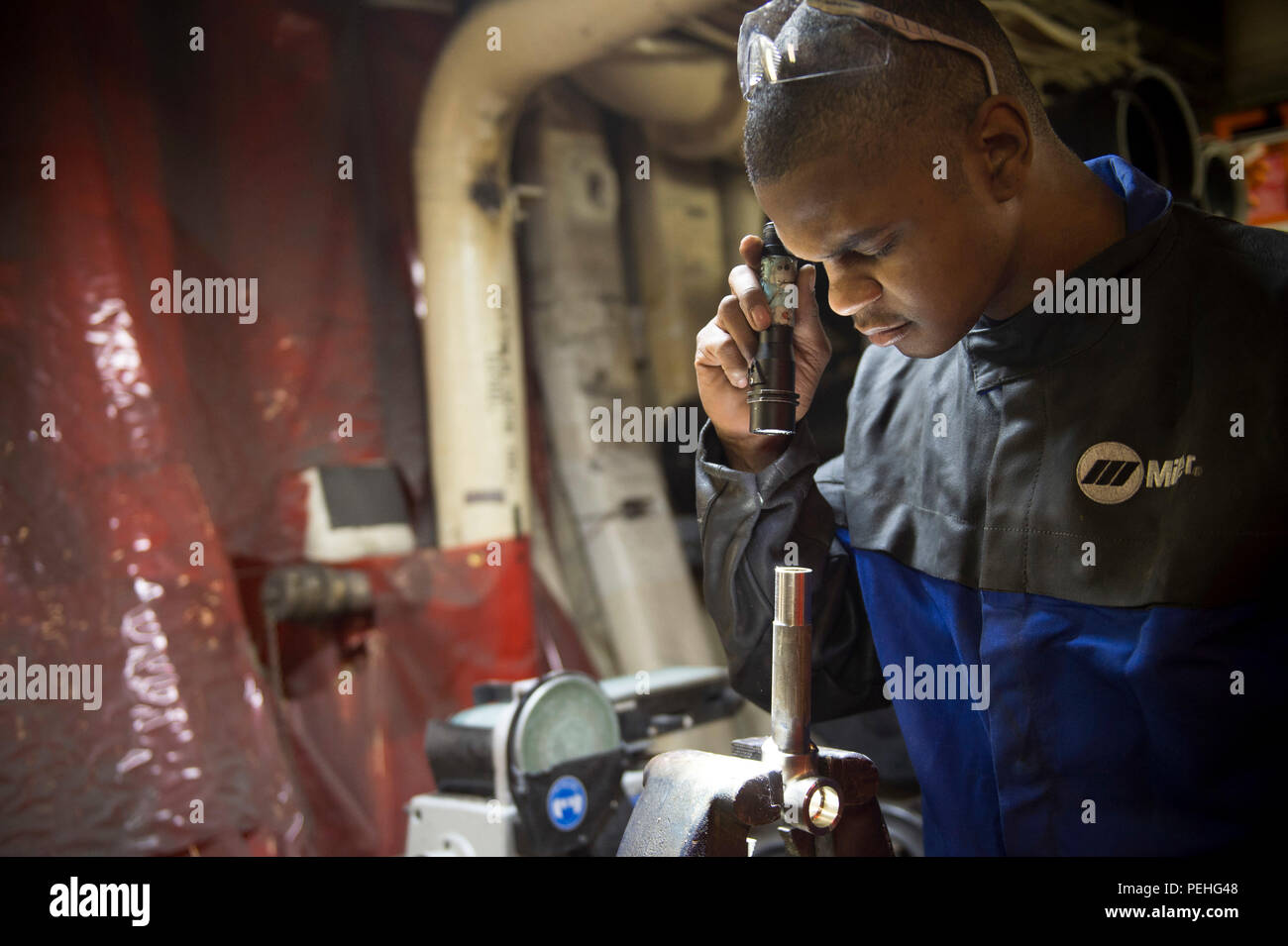 Petty Officer 2nd Class Chris Stevenson, a damage controlman aboard ...