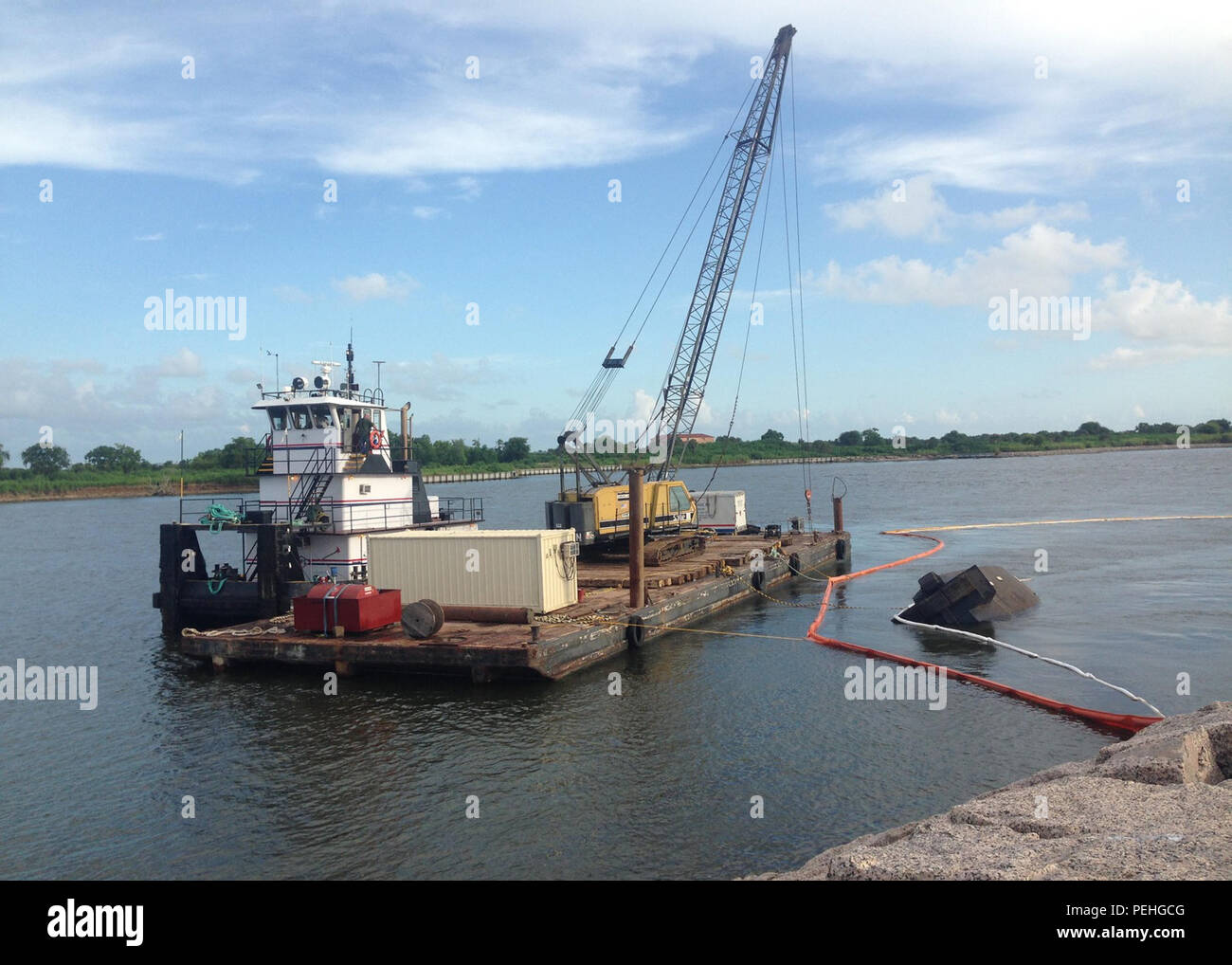 Response crews work from a spud barge to conduct salvage and recover ...