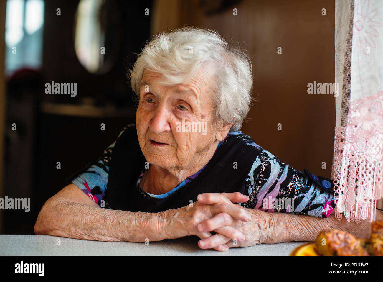 An elderly woman at the dinner table Stock Photo - Alamy