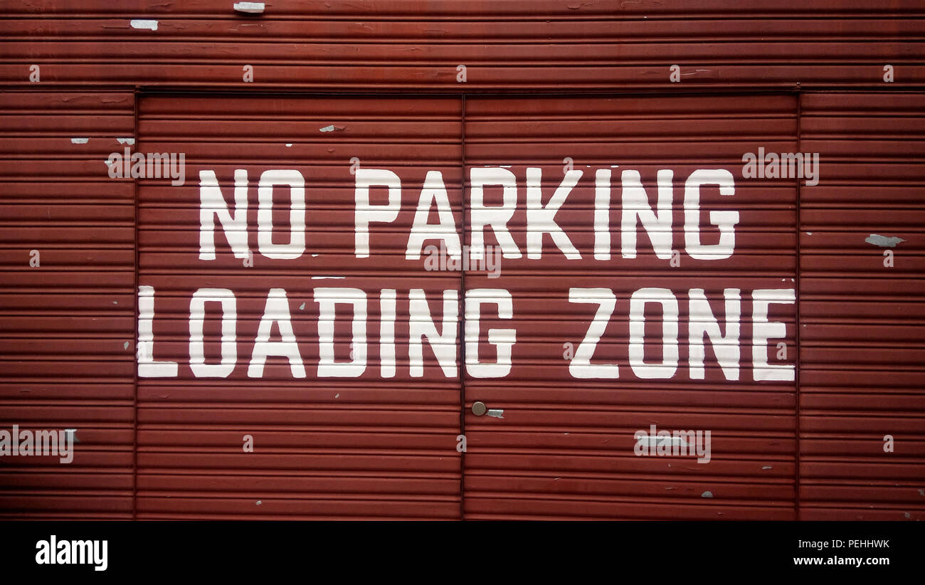 No parking loading zone sign on red metal door Stock Photo - Alamy