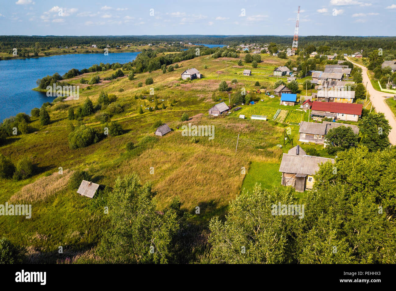 Bird's eye view of Ladva village and Oyat river, green fields and ...