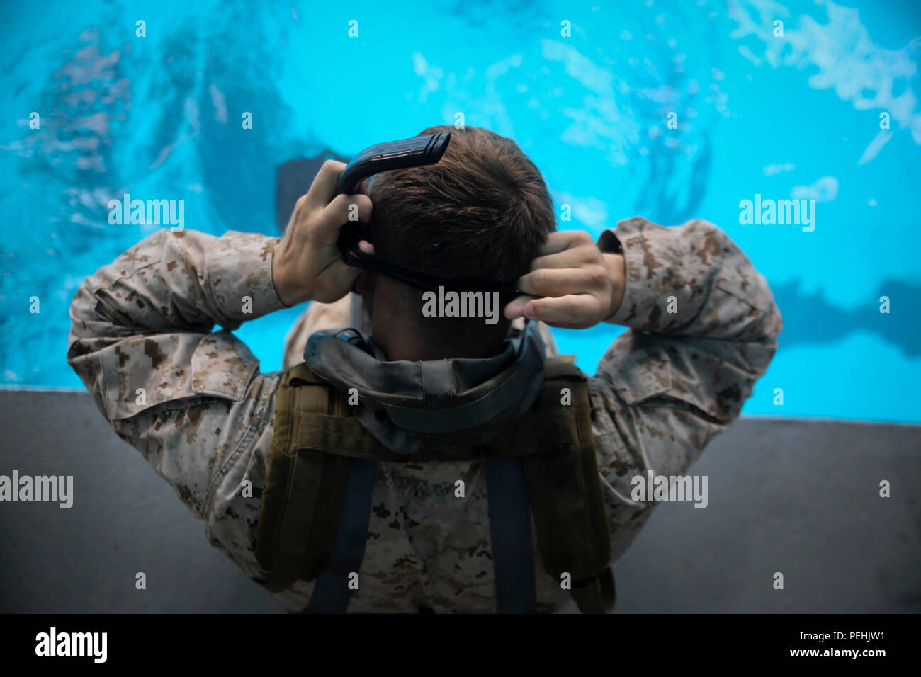 A Marine with 2nd Reconnaissance Battalion conducts a final check of ...
