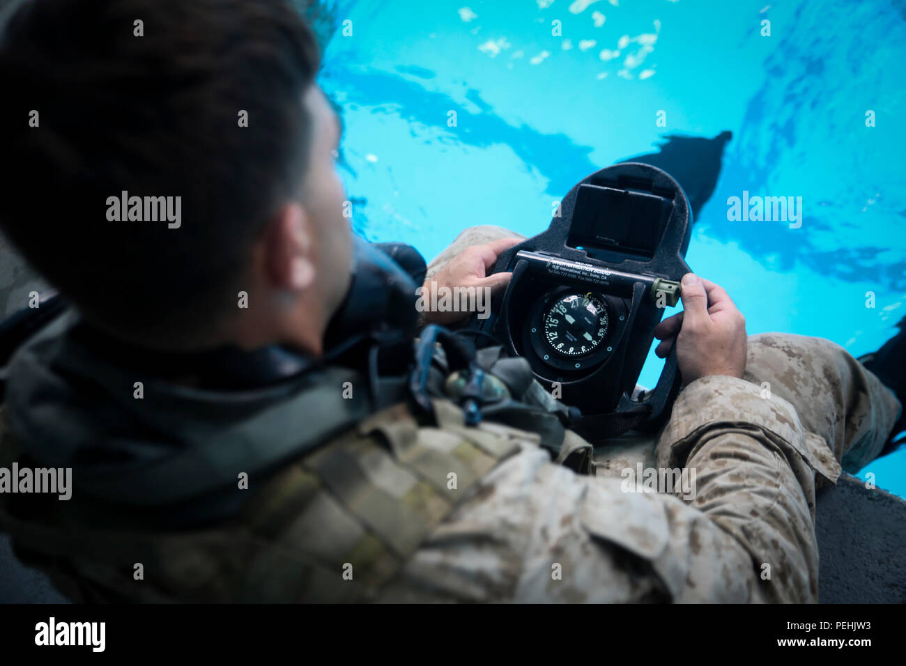 A Marine with 2nd Reconnaissance Battalion conducts a final check of ...