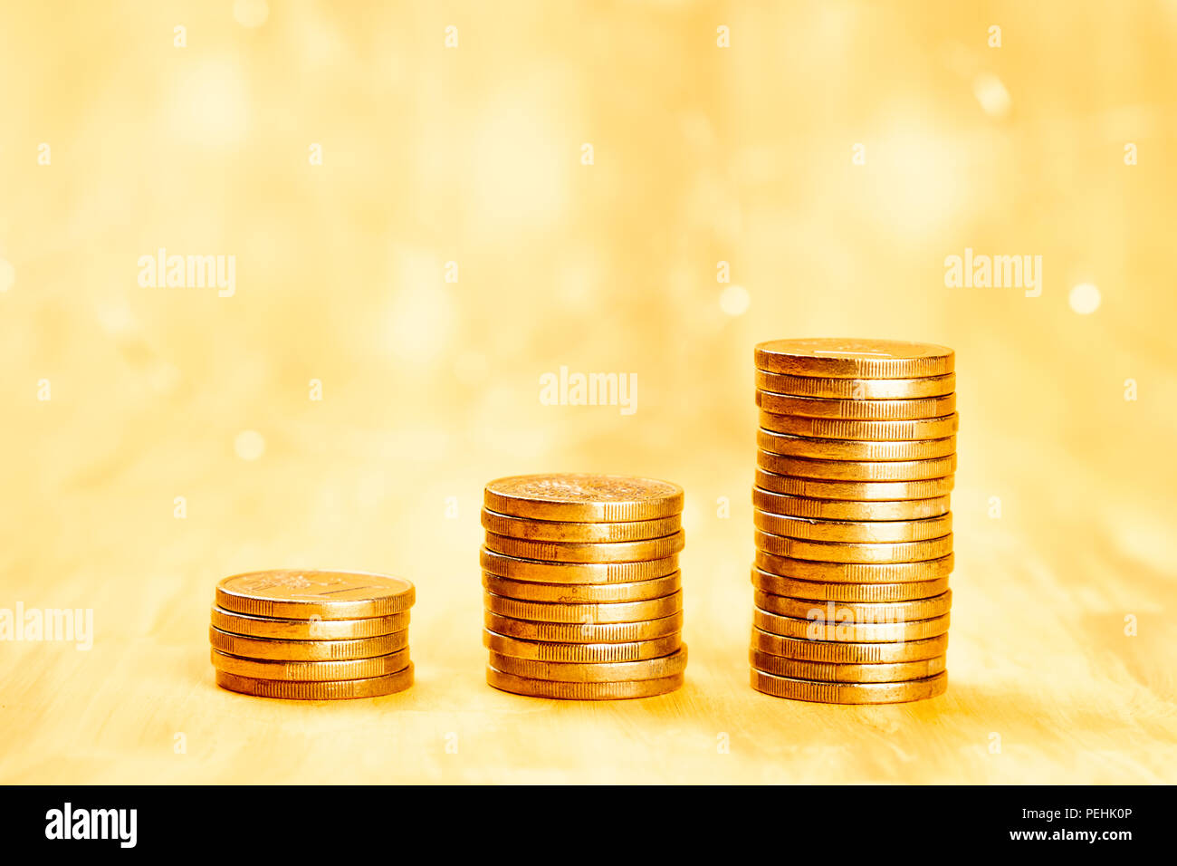 Money background, stacks of coins on an abstract golden texture with ...