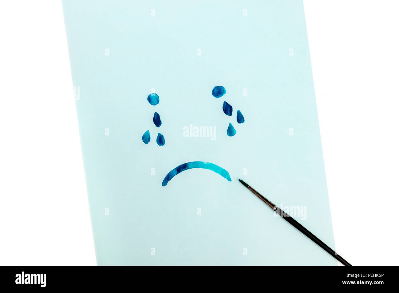 Blue, sad face with tears, hand painted on blue paper in watercolor ...