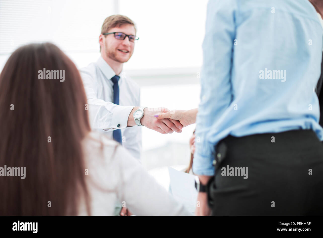 Bank Manager and the customer shake hands after signing a lucrative ...