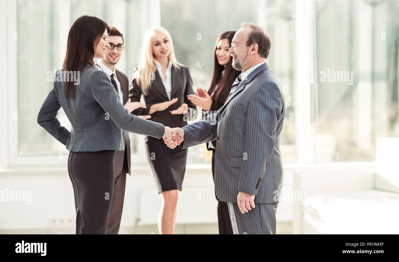 welcome and handshake of business partners on the background of applauding employees Stock Photo ...