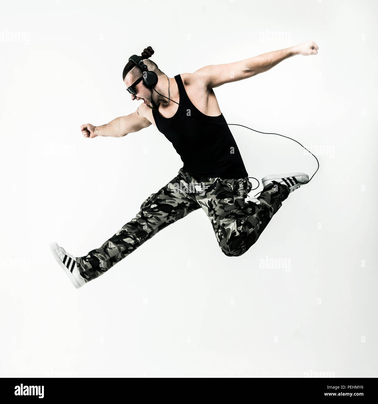 emotional and charismatic DJ - rapper with headphones on a white Stock ...