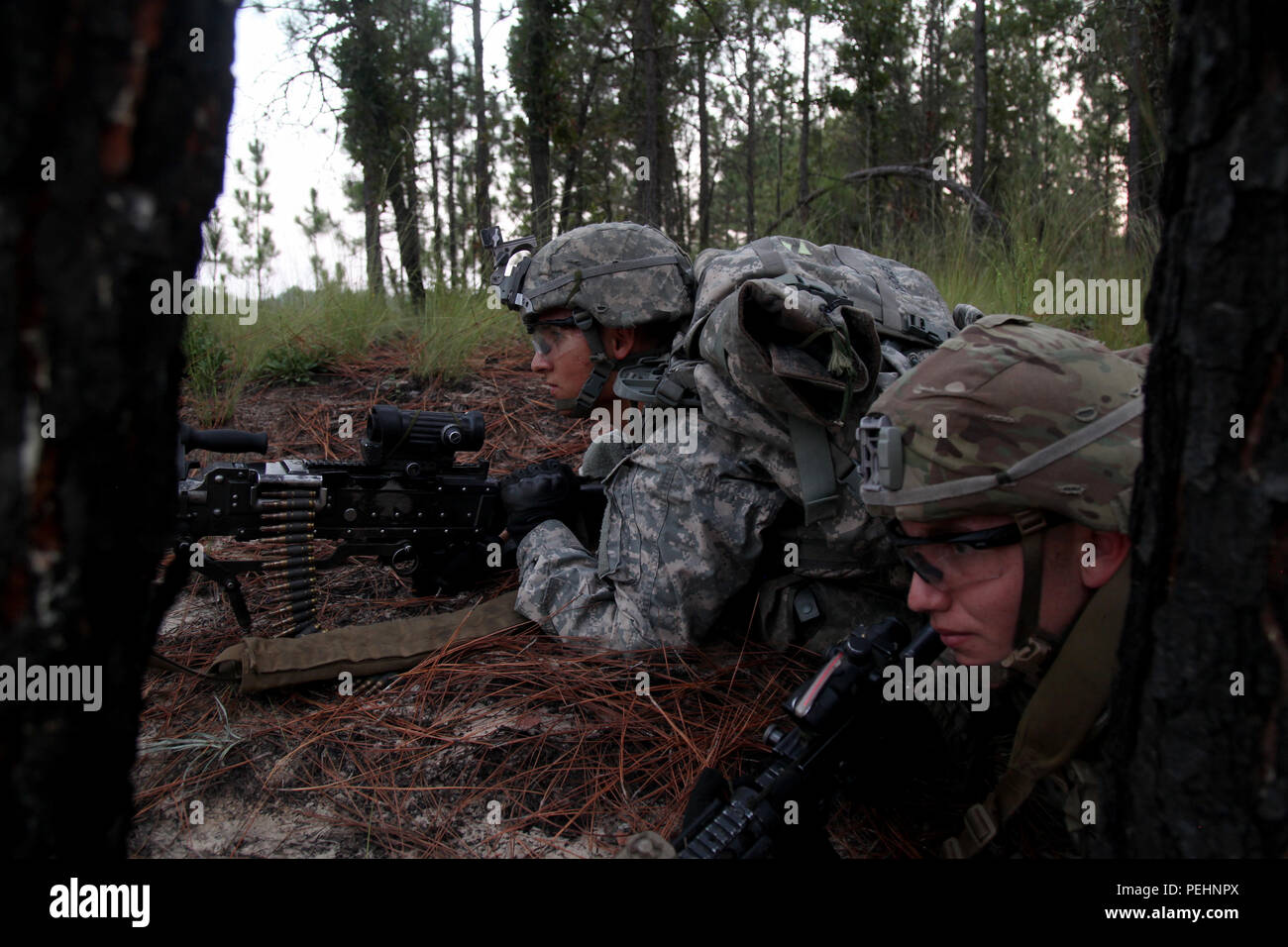 Spc. Cory Shockley mans the M249 squad automatic weapon and Spc. Jordan ...