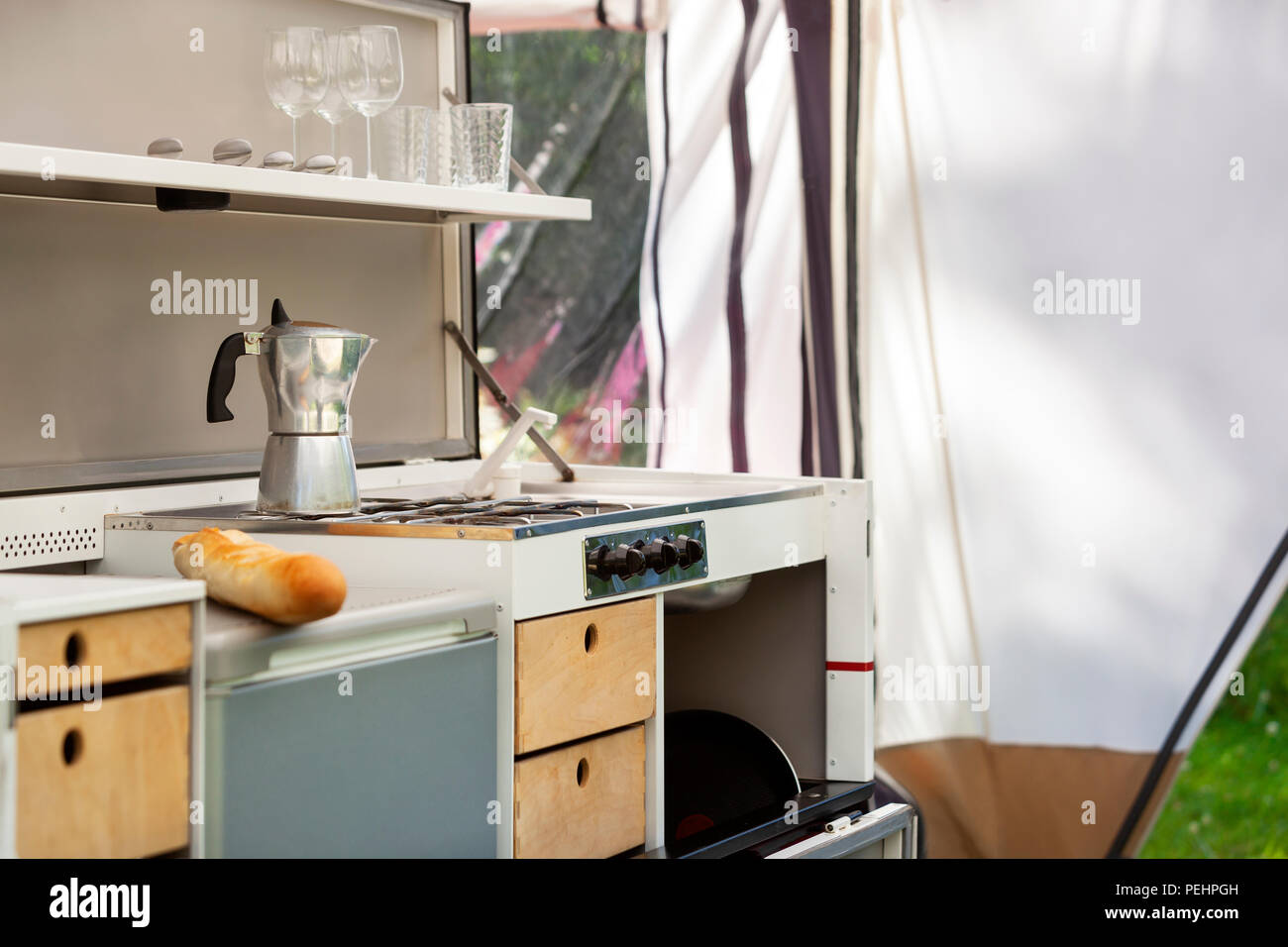 Camping or glamping with a kitchen in a tent Stock Photo - Alamy