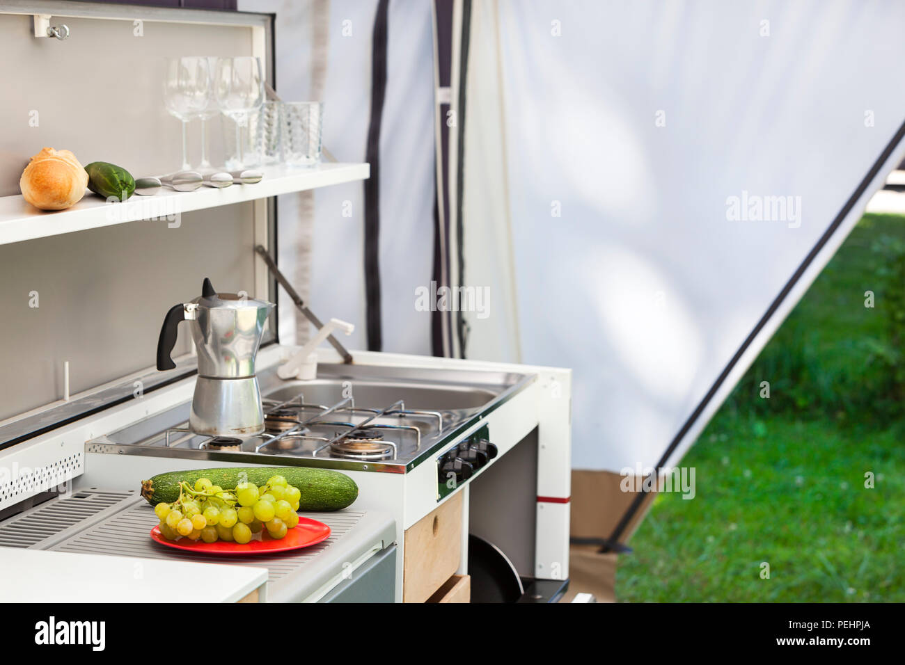 Camping or glamping with a kitchen in a tent Stock Photo - Alamy