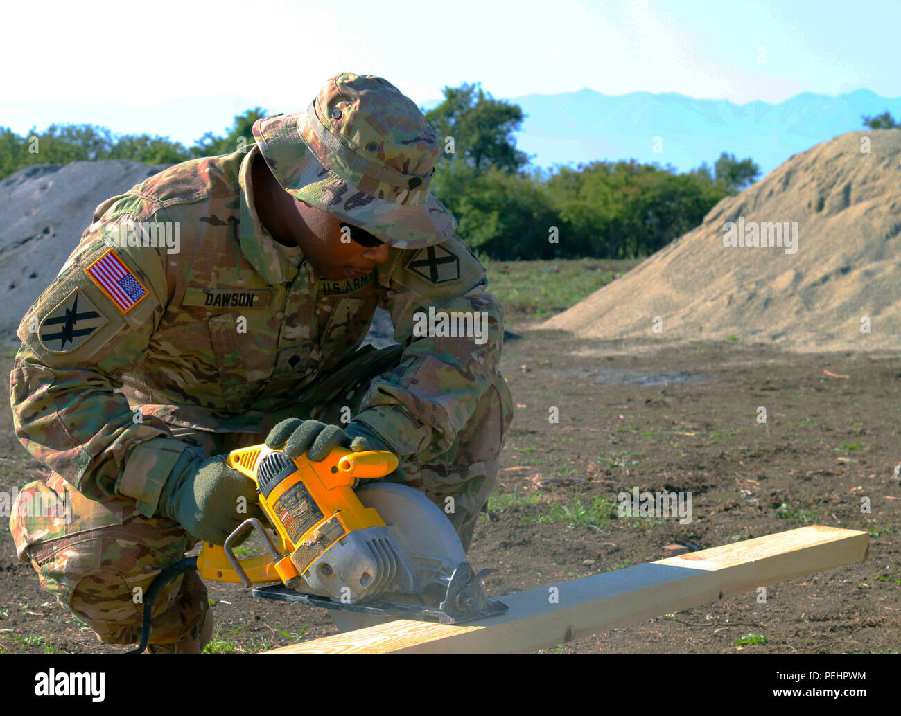 Spc. Devante Dawson, a carpenter with the 166th Engineer Company, saws ...
