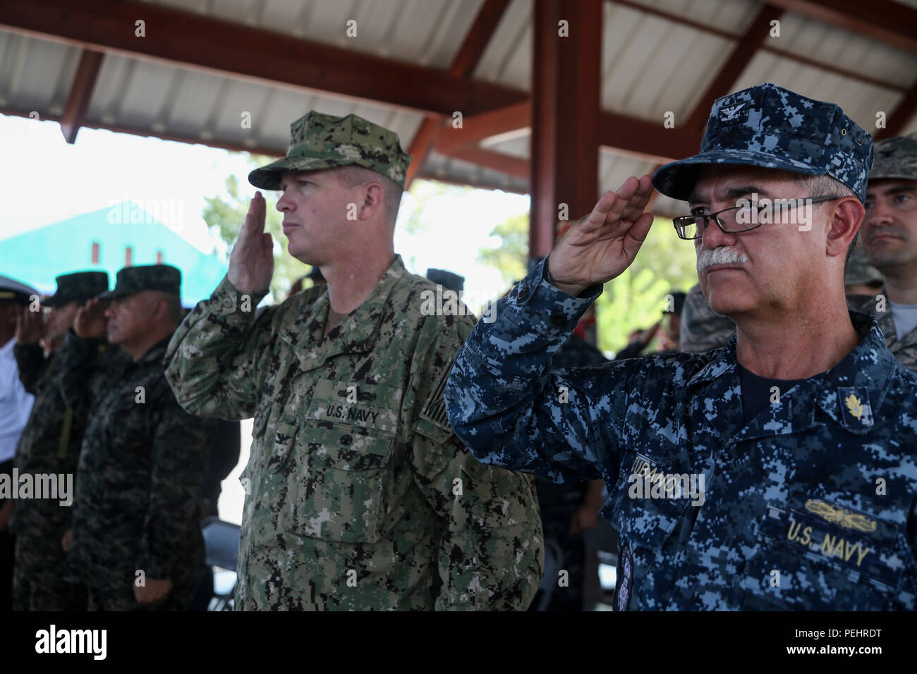 Military personnel from the United States and Honduras render a salute ...