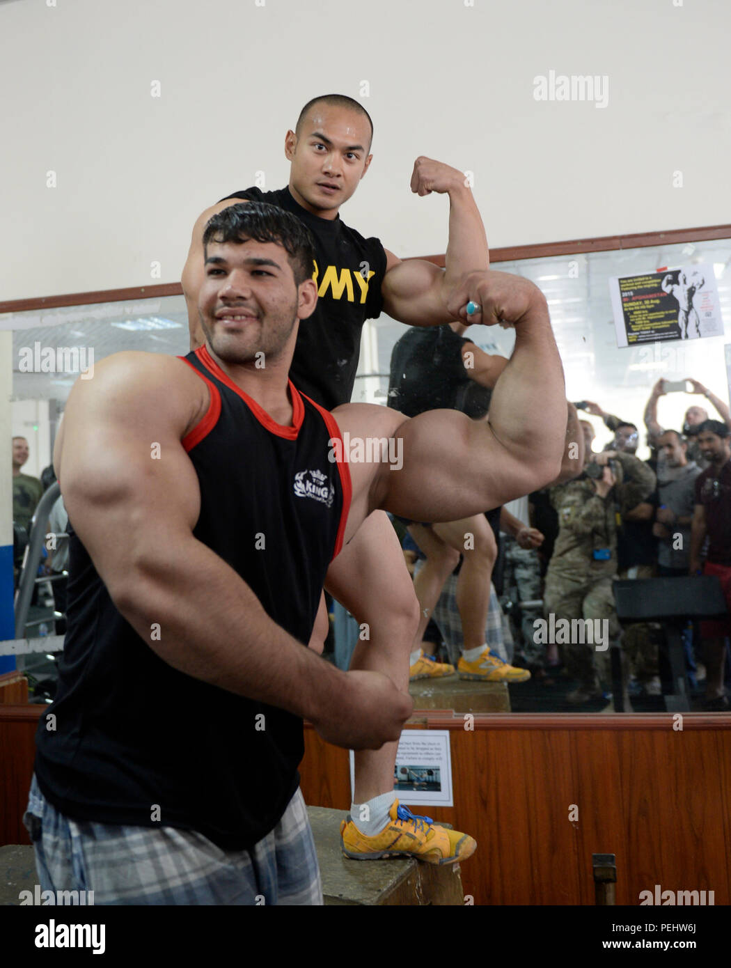 U.S. Army Sgt. Alex Hardin winner of the 'best guns' contest flexes ...