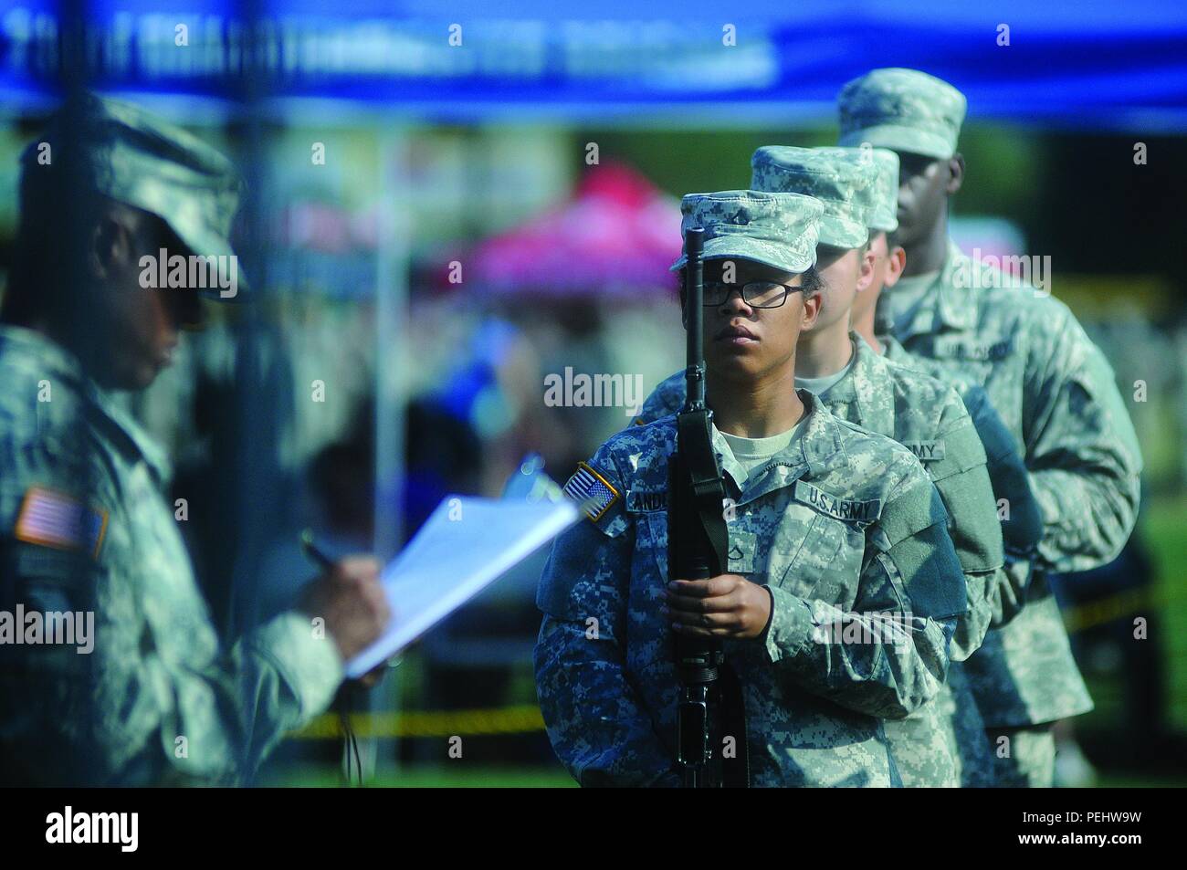 Soldiers stand at the position of present arms as Command Sgt. Maj ...