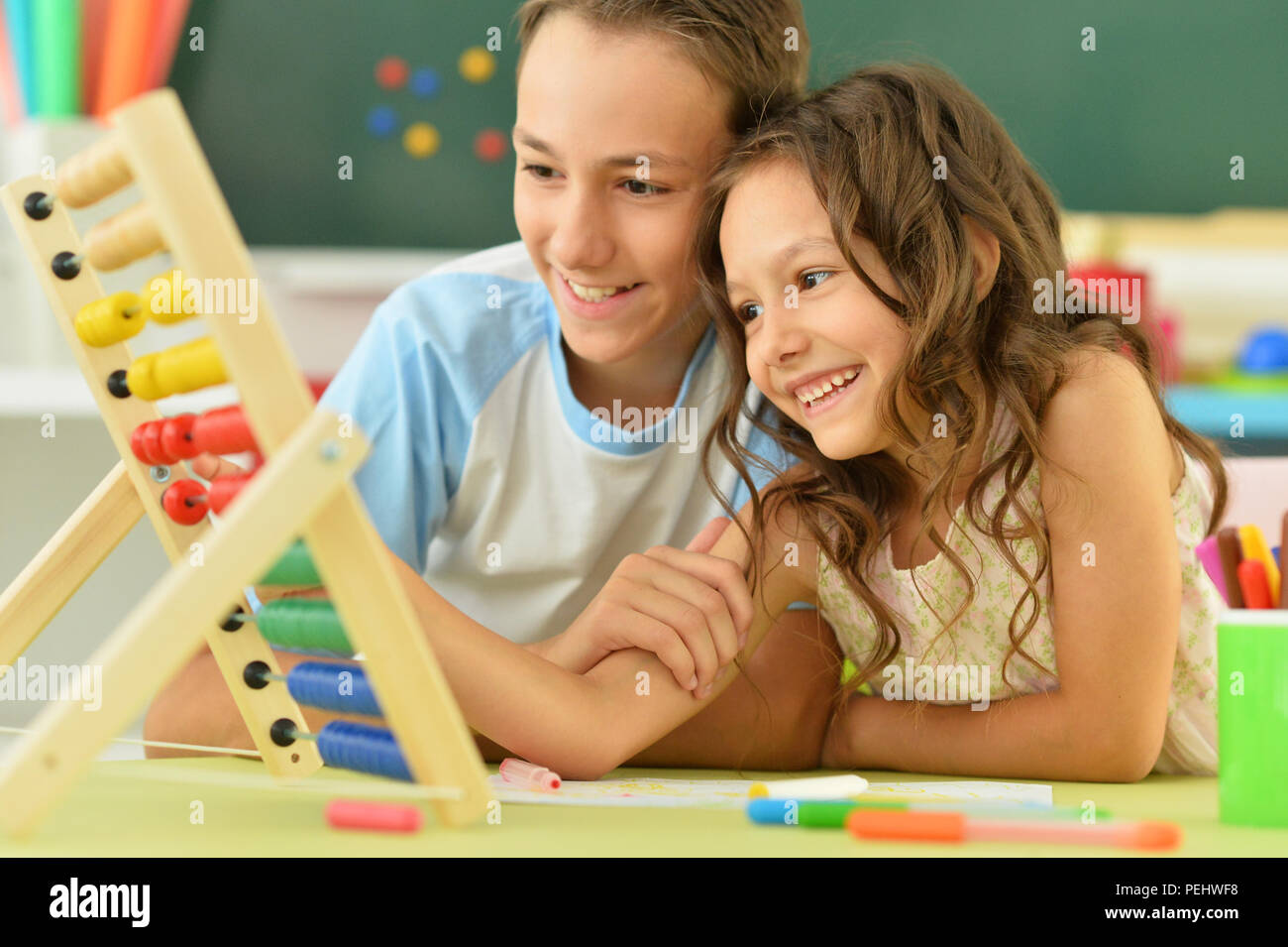 Portrait of a little girl counting on abacus Stock Photo - Alamy