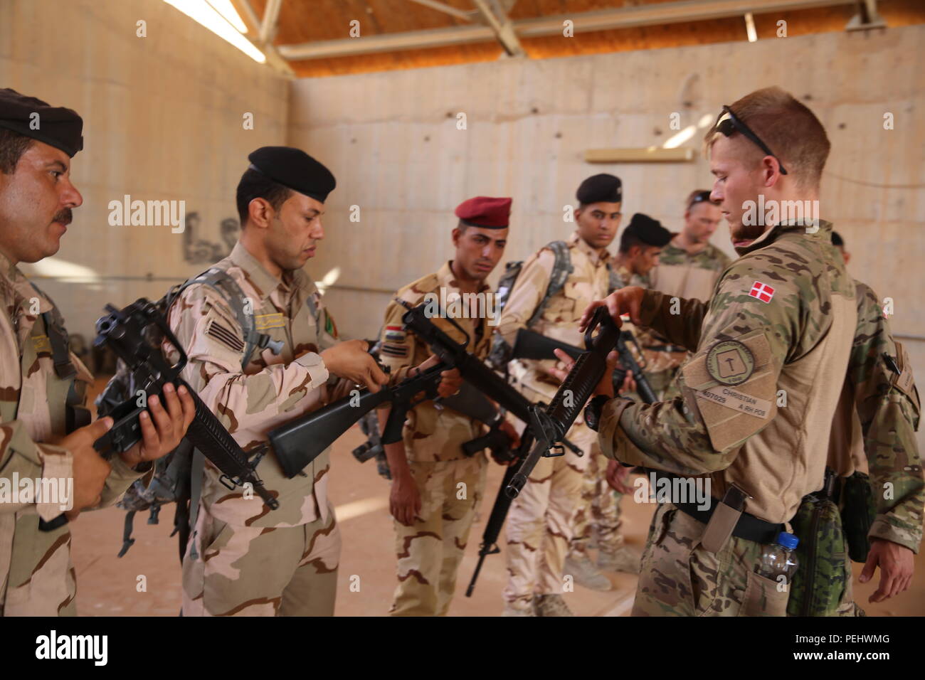 A Royal Danish army service member teaches members of the 75th Iraqi ...