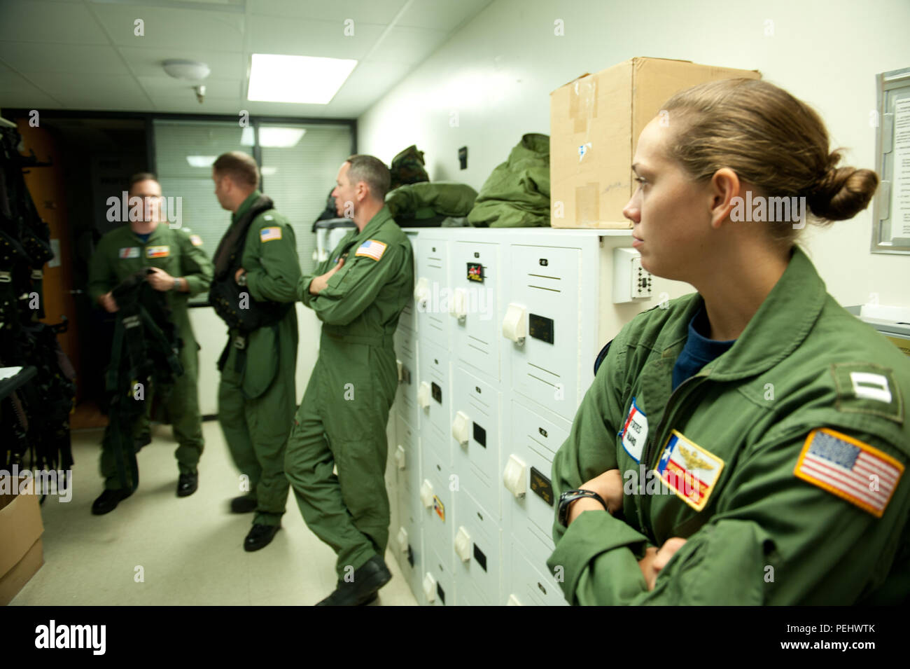 Lt. Amanda Frederick, a Coast Guard pilot, listens to a safety brief at ...