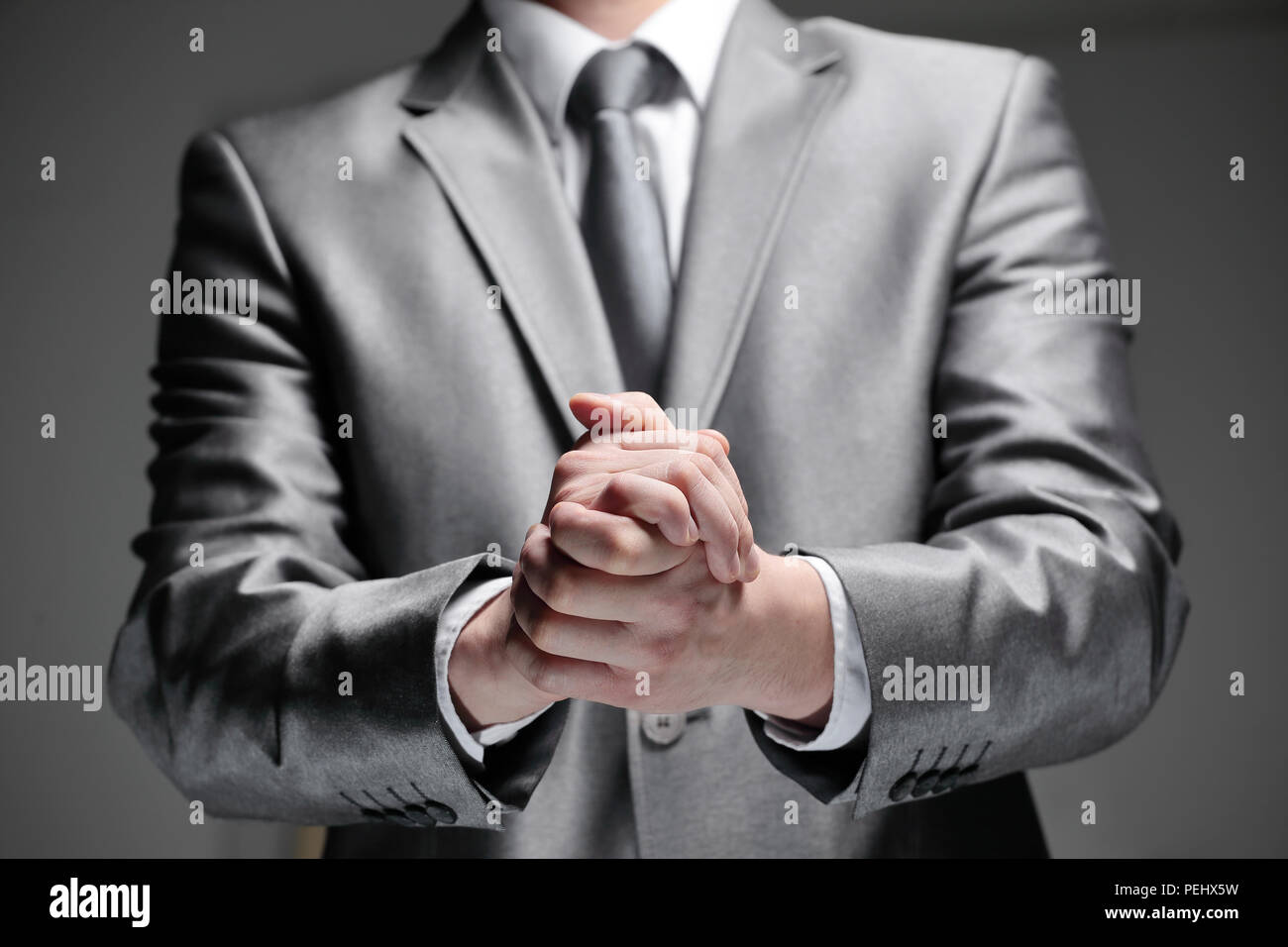 close up.businessman folded his hands .isolated on black background ...