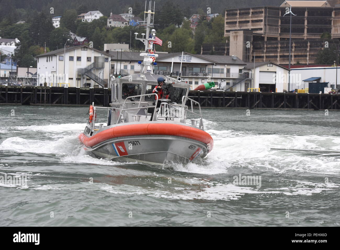 Petty Officer 2nd Class Michael Klosterman maneuvers a Coast Guard ...