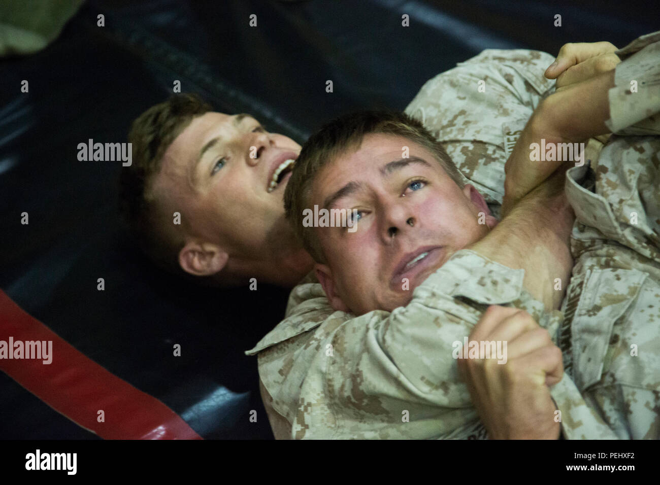 Capt. Joshua Fernandez practices a rear choke on Cpl. Michael Dempich ...