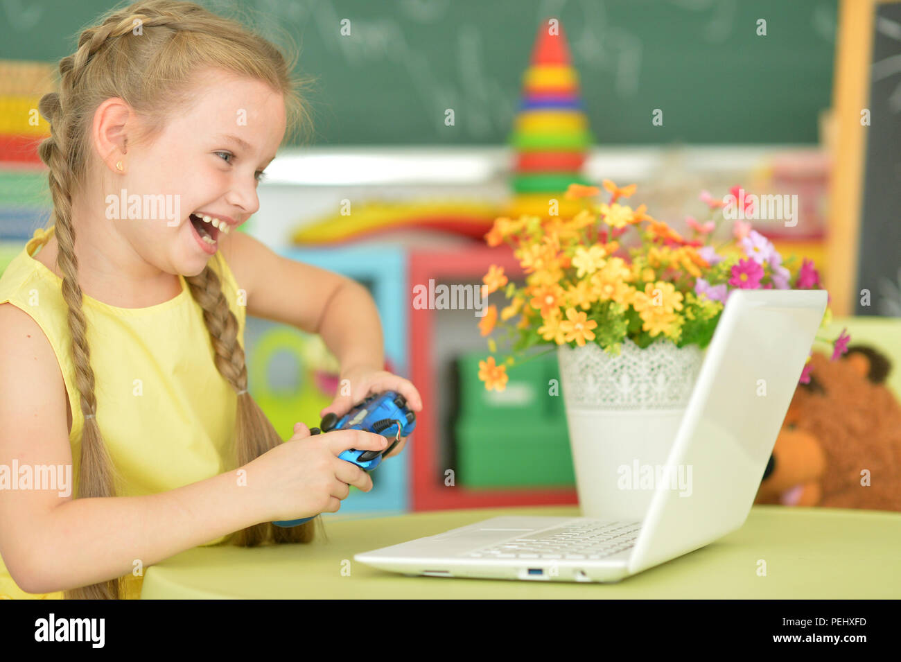 Portrait of a little girl using modern laptop Stock Photo - Alamy