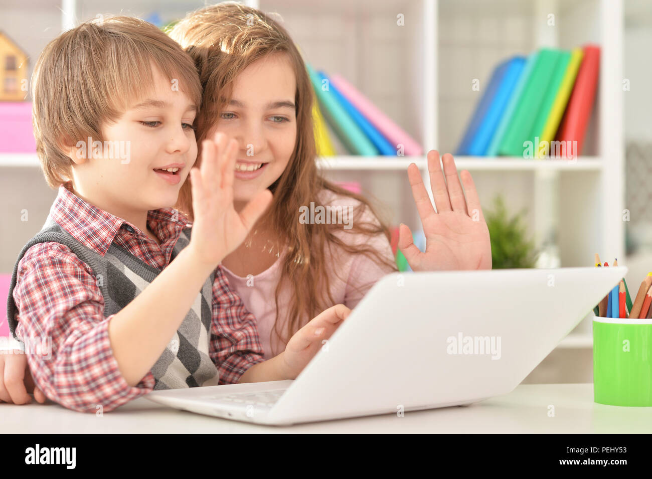 Portrait of a boy and girl using laptop Stock Photo - Alamy