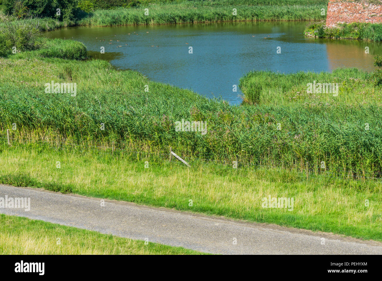 big pond with road Stock Photo - Alamy