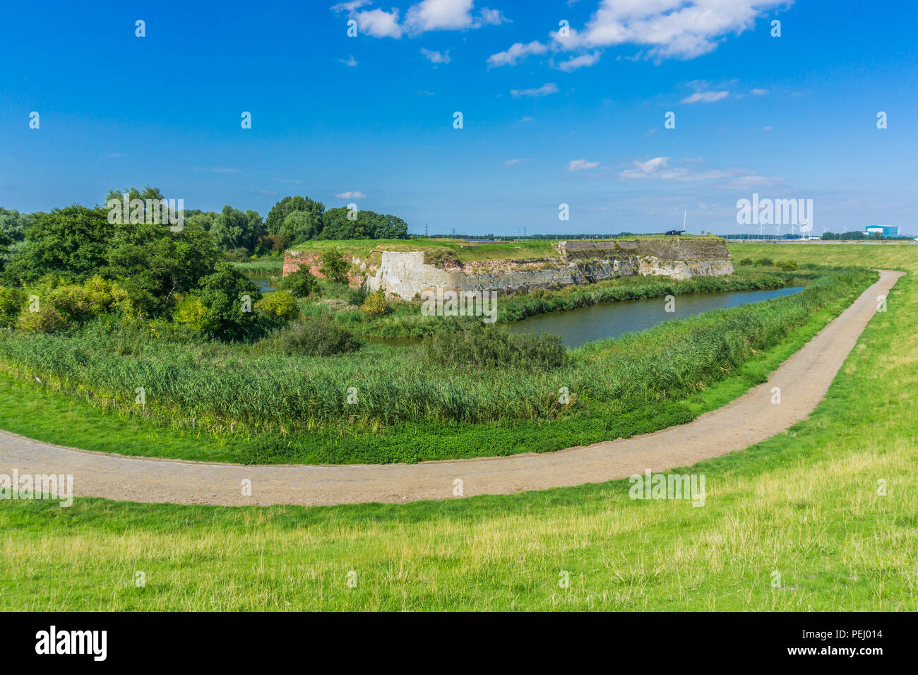 road with water landscape and big wall Stock Photo - Alamy