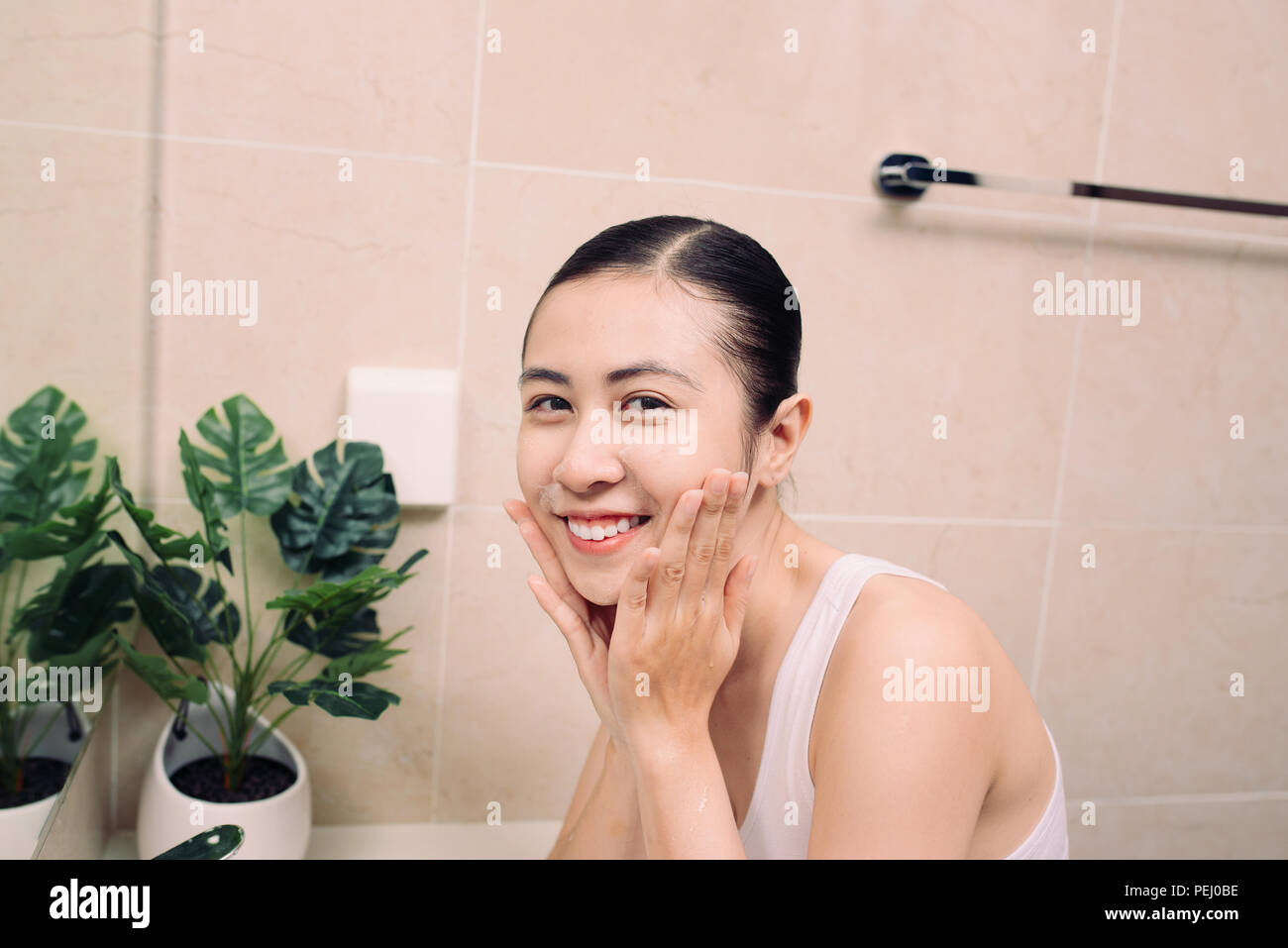 Woman washing her face hi-res stock photography and images - Alamy