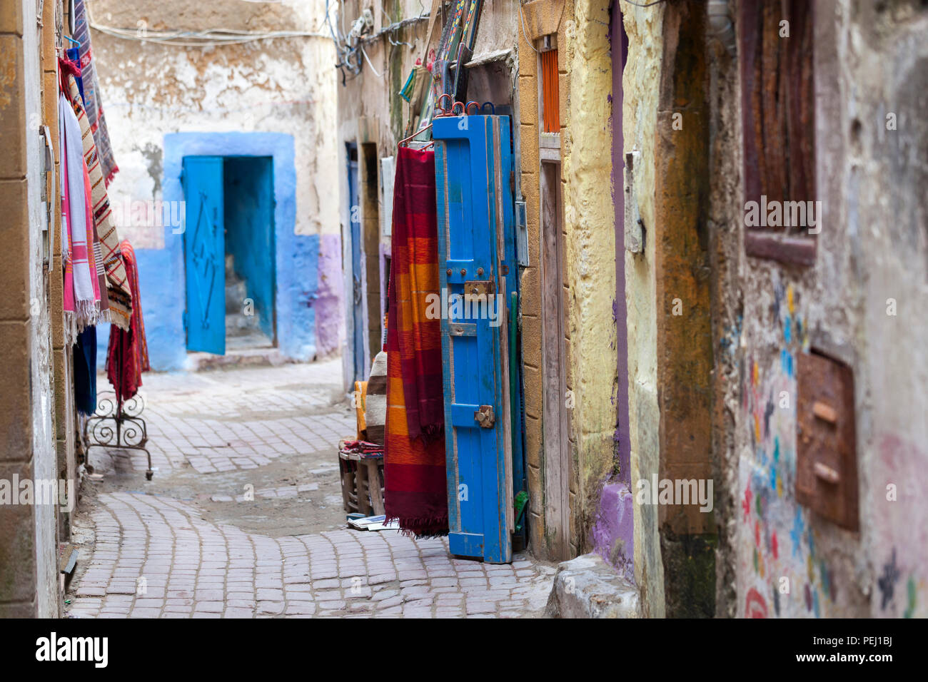 Narrow colorful street in the old medina of Essaouira in Morocco Stock ...