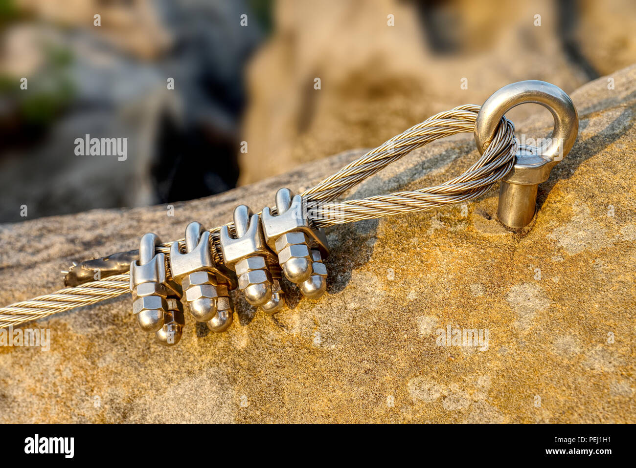 steel fixed rope for via ferrata. Climbing carabiner attached to the ...