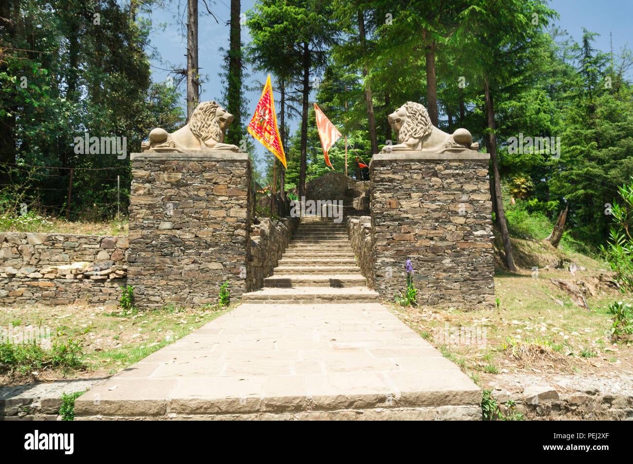 entry gate with stone entrance lion statue and flags Stock Photo - Alamy