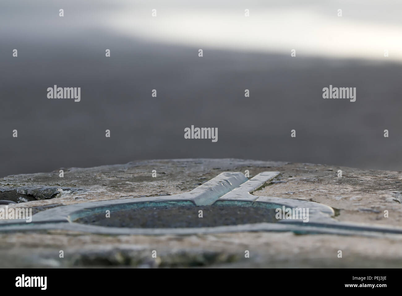 Trig point at Sand Point, Somerset, with out of focus background ...