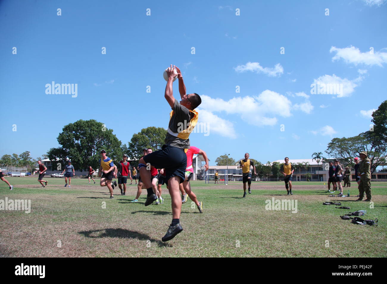 A soldier with the People’s Liberation Army jumps to catch a ball ...