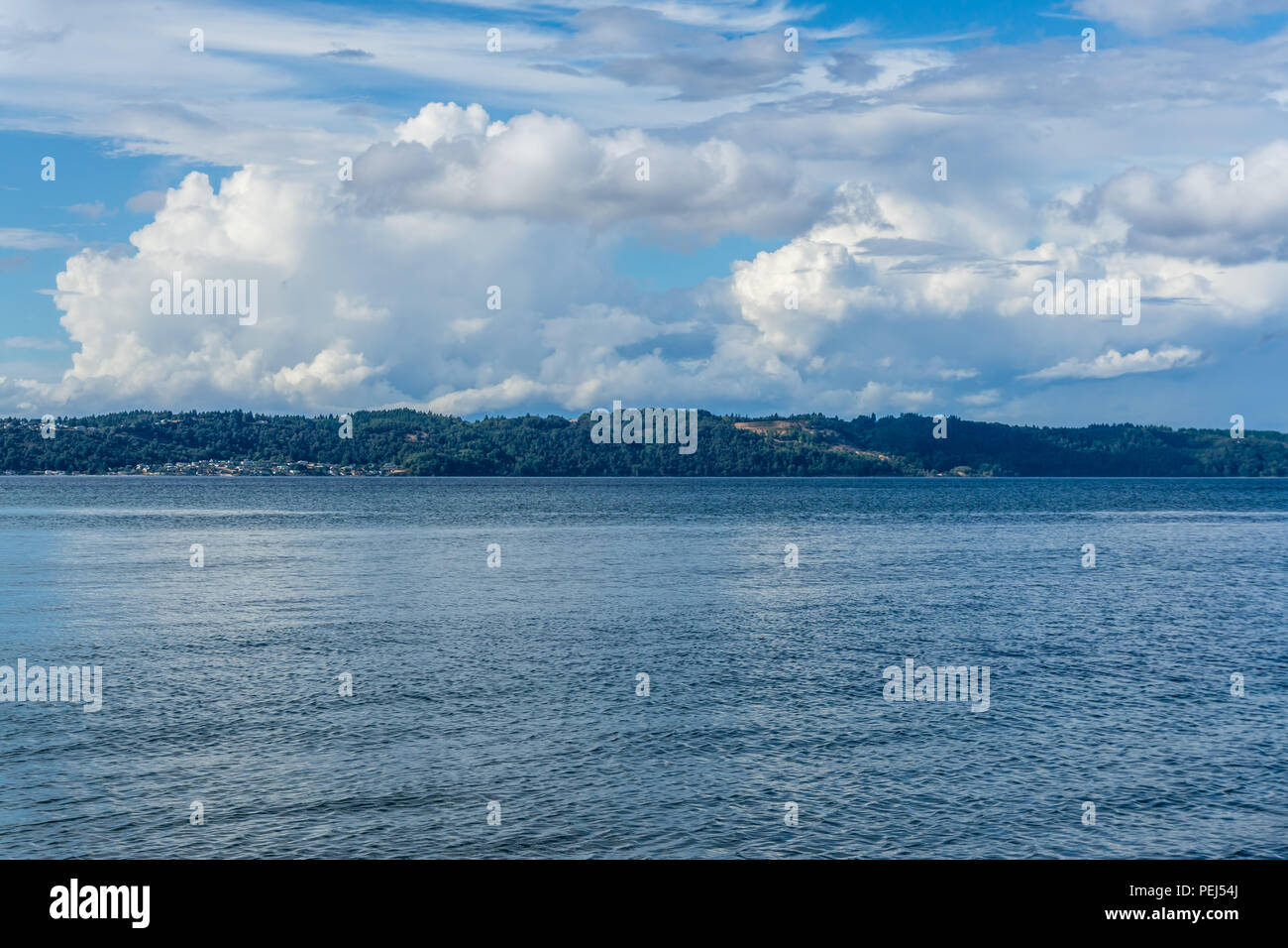 Billowing clouds hover over Maury Island in Washington State Stock ...