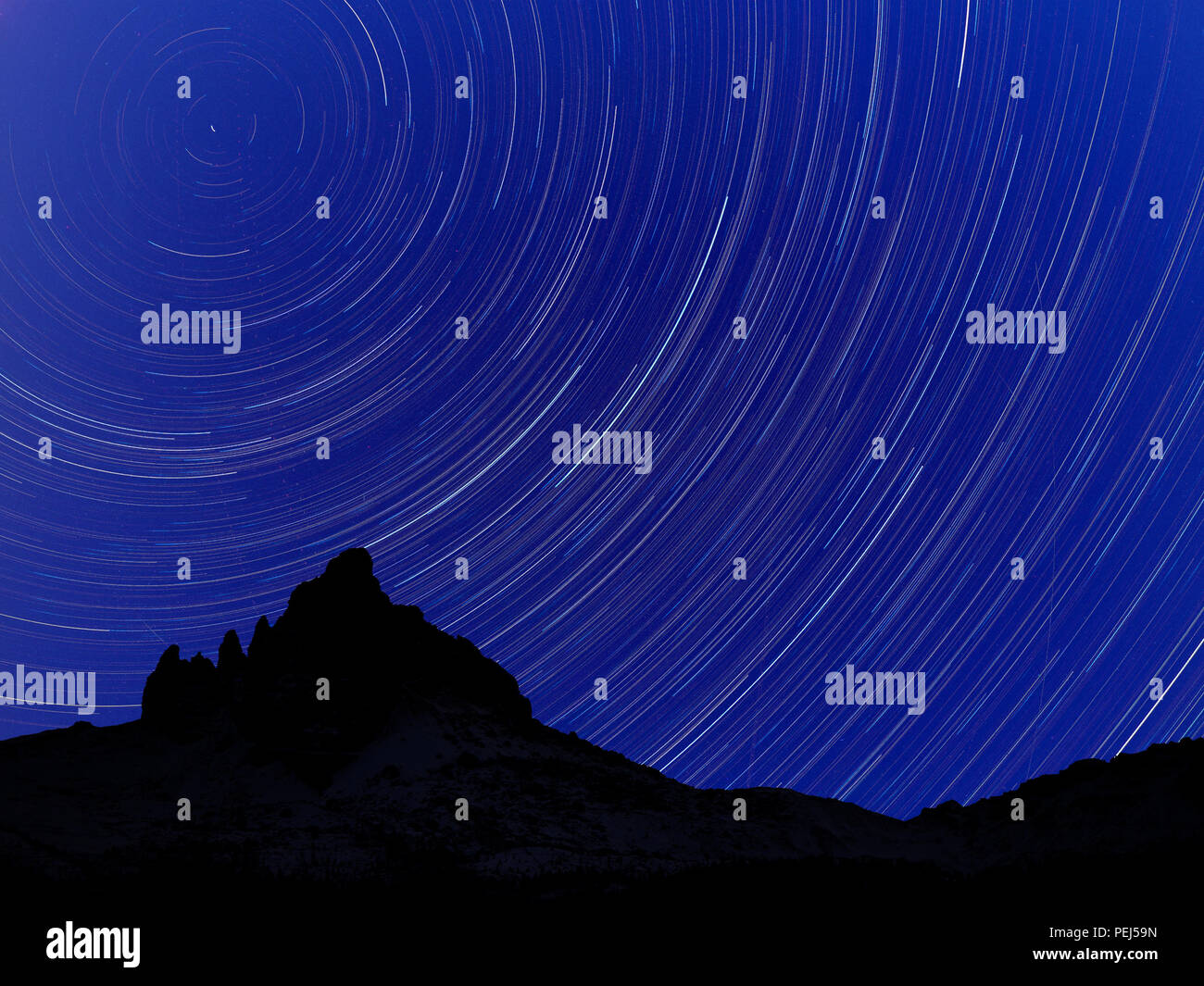 Long exposure image showing Night sky star trails over mountains Stock ...