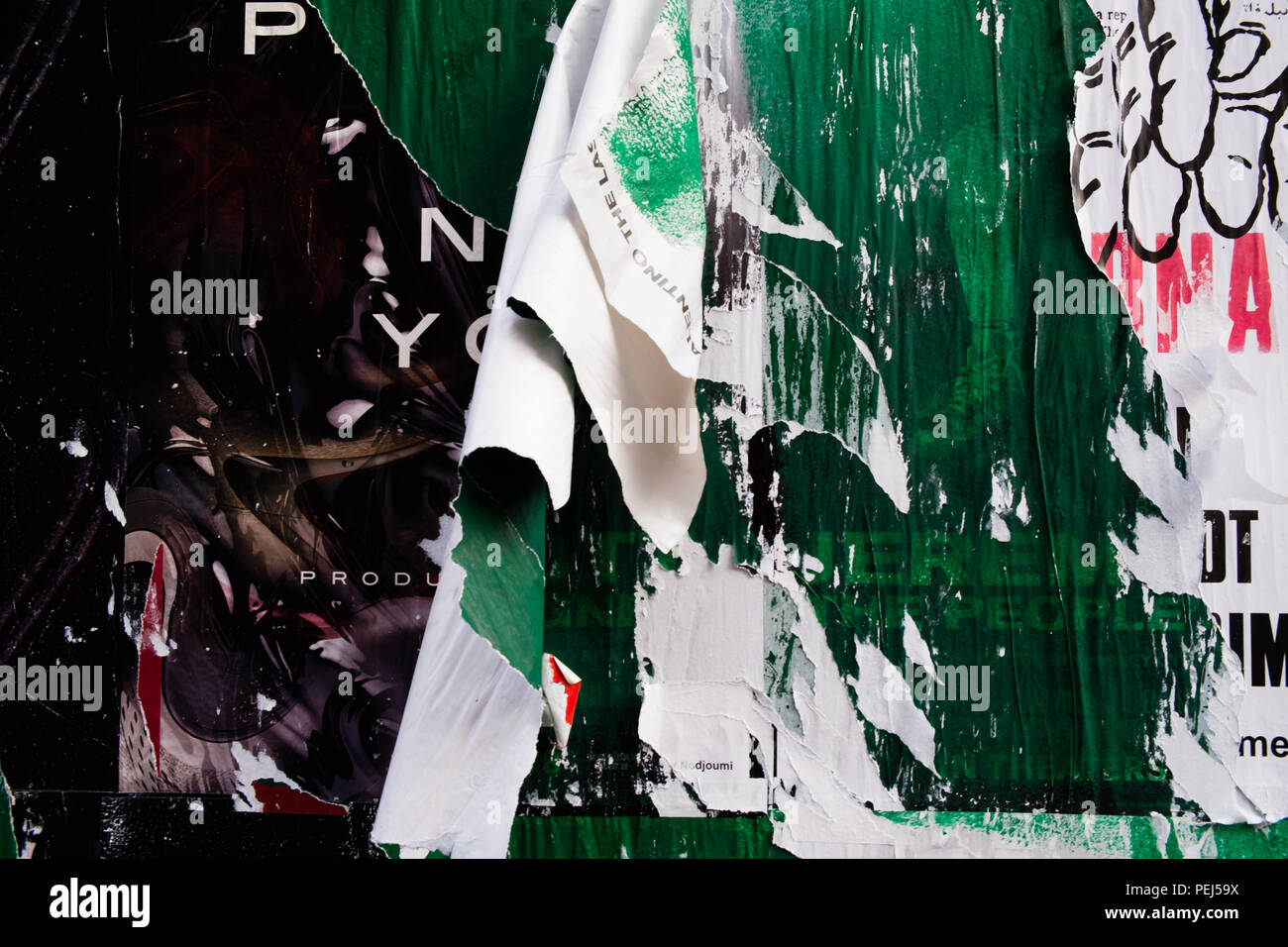 A torn poster revealing another one underneath, New York City Stock ...