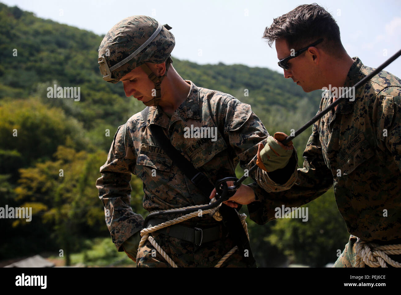 Lance Cpl. Derrek A. Tuttle, left, prepares to rappel off a Republic of ...