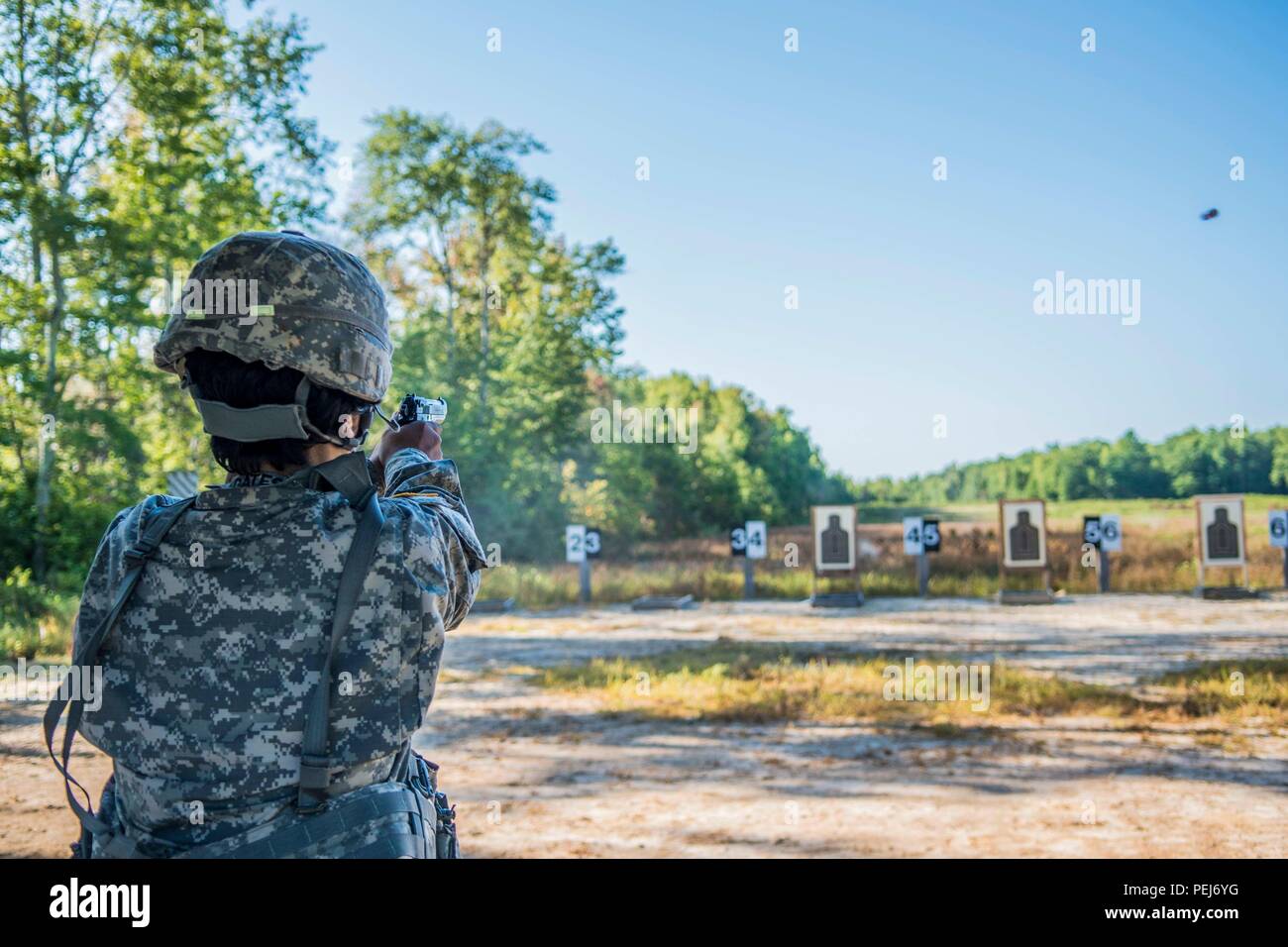 A female Army Public Health Command captain fires her M9 weapon at a ...