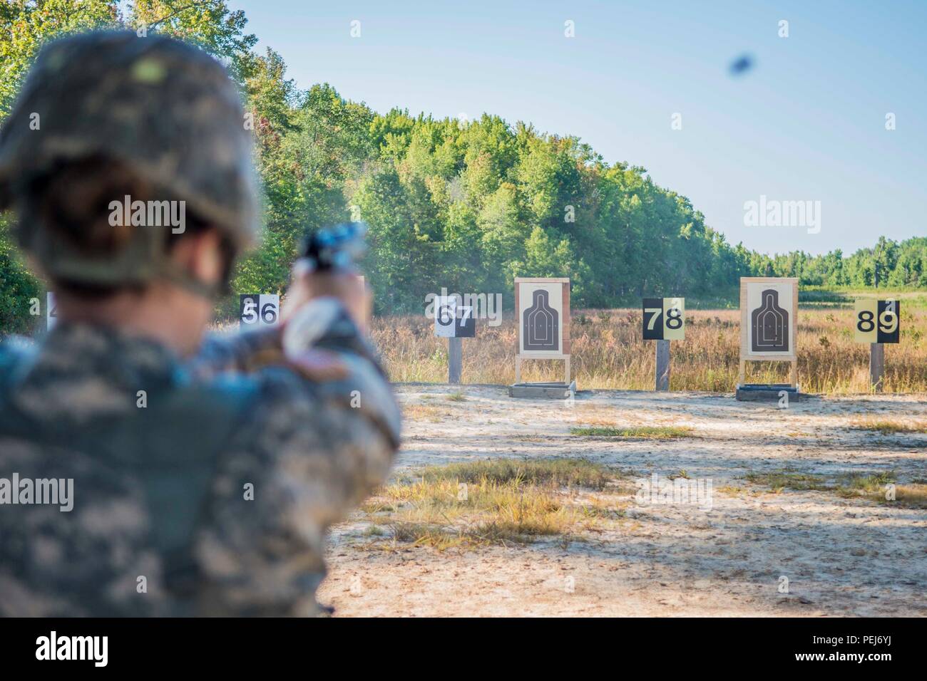 Army Public Health Center Spc. Katherine B. Scott fires her weapon at a ...