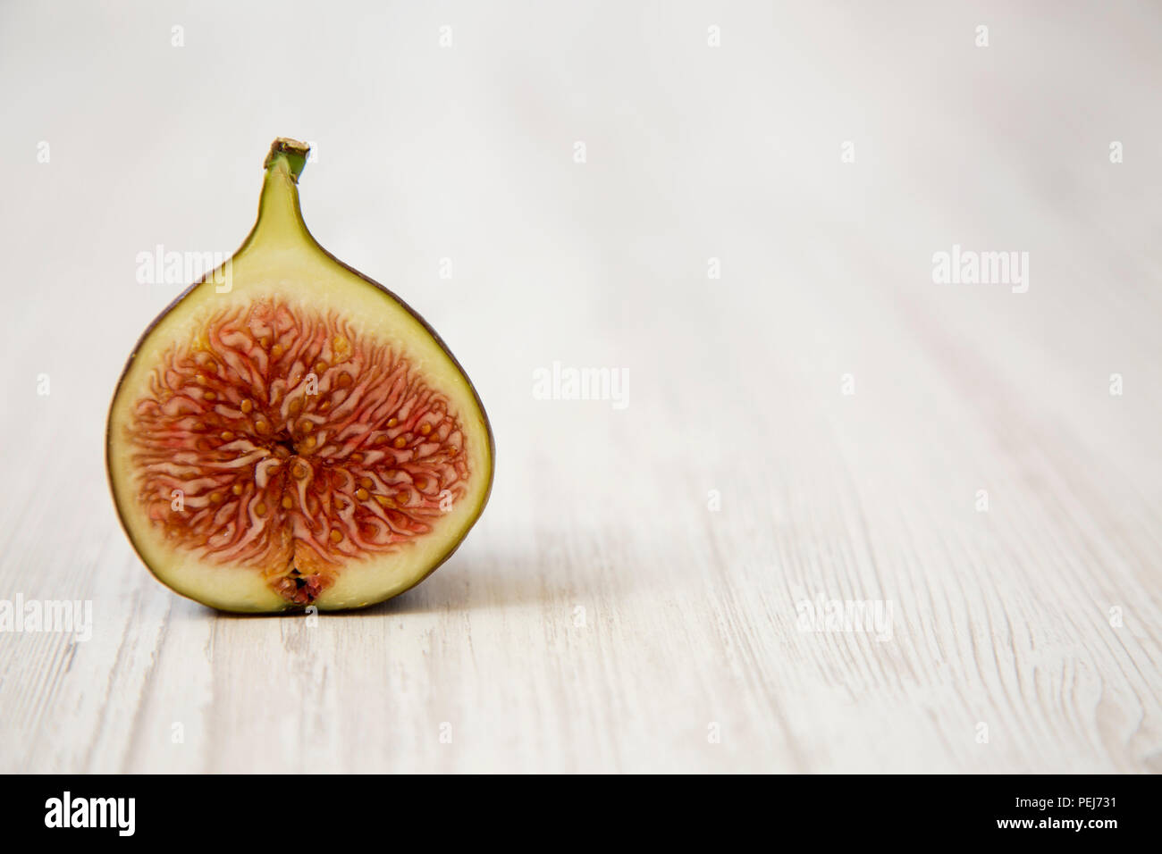 Half a fig, side view. Closeup. Copy space Stock Photo - Alamy