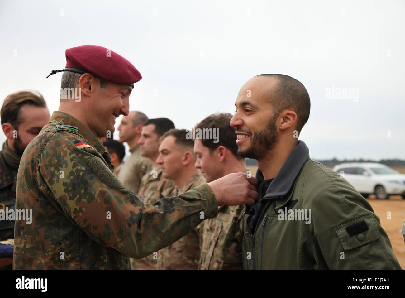 A Dutch Marine receives German jump wings from a German jumpmaster at ...