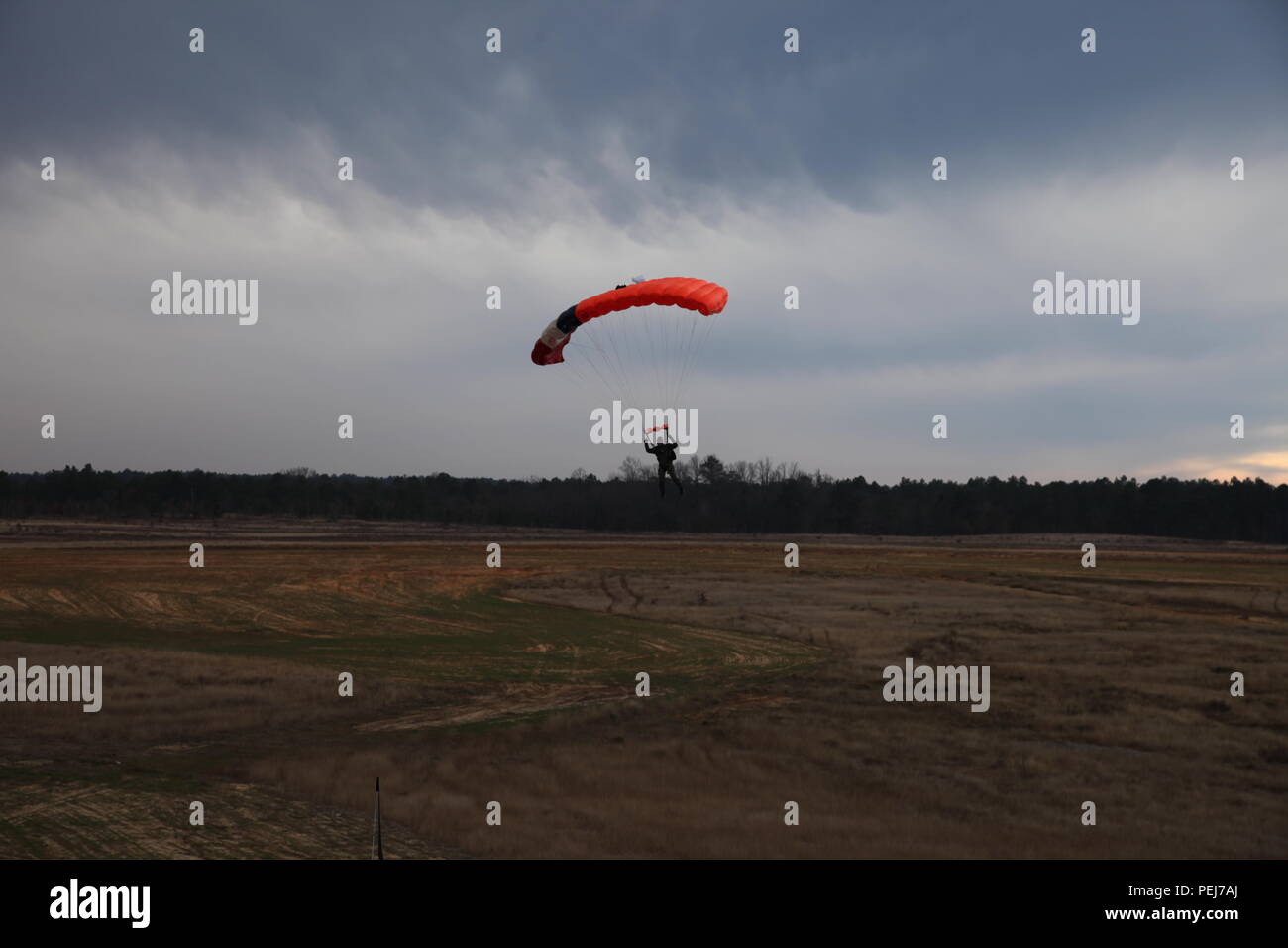 A U.S. Army paratrooper prepares to land on Luzon Drop Zone during an ...