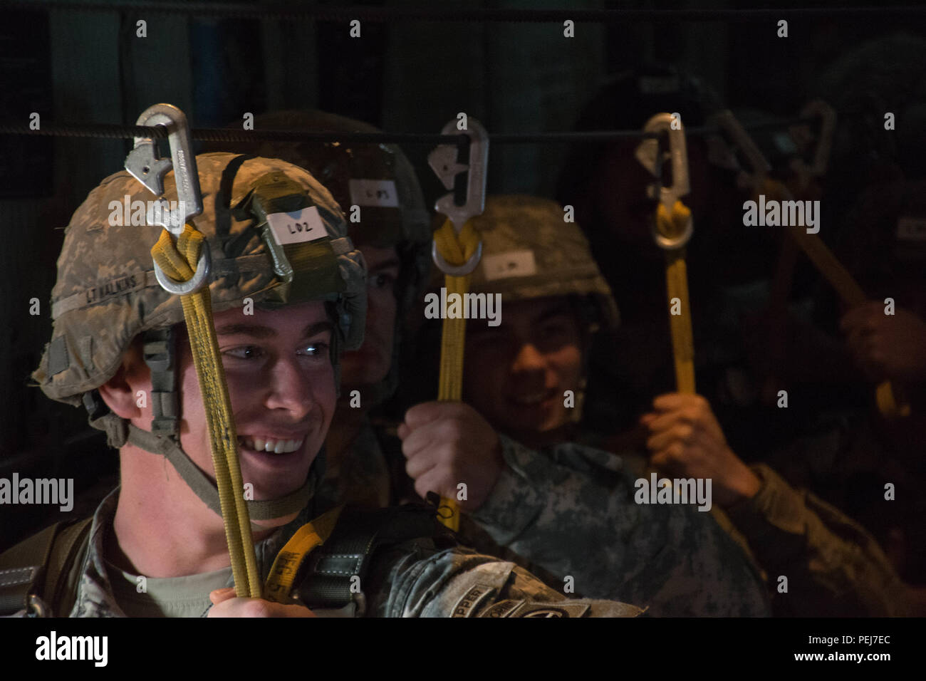 U.S. Army paratroopers from the 82nd Airborne Division await the green ...