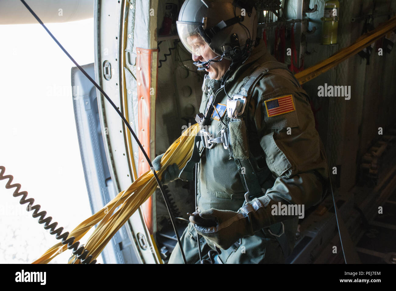 A U.S. Air Force loadmaster pulls static lines inside C-130 after ...