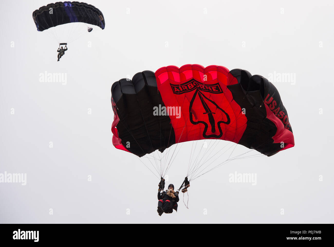 A U.S. Army Special Operations Forces parachute team member descends ...