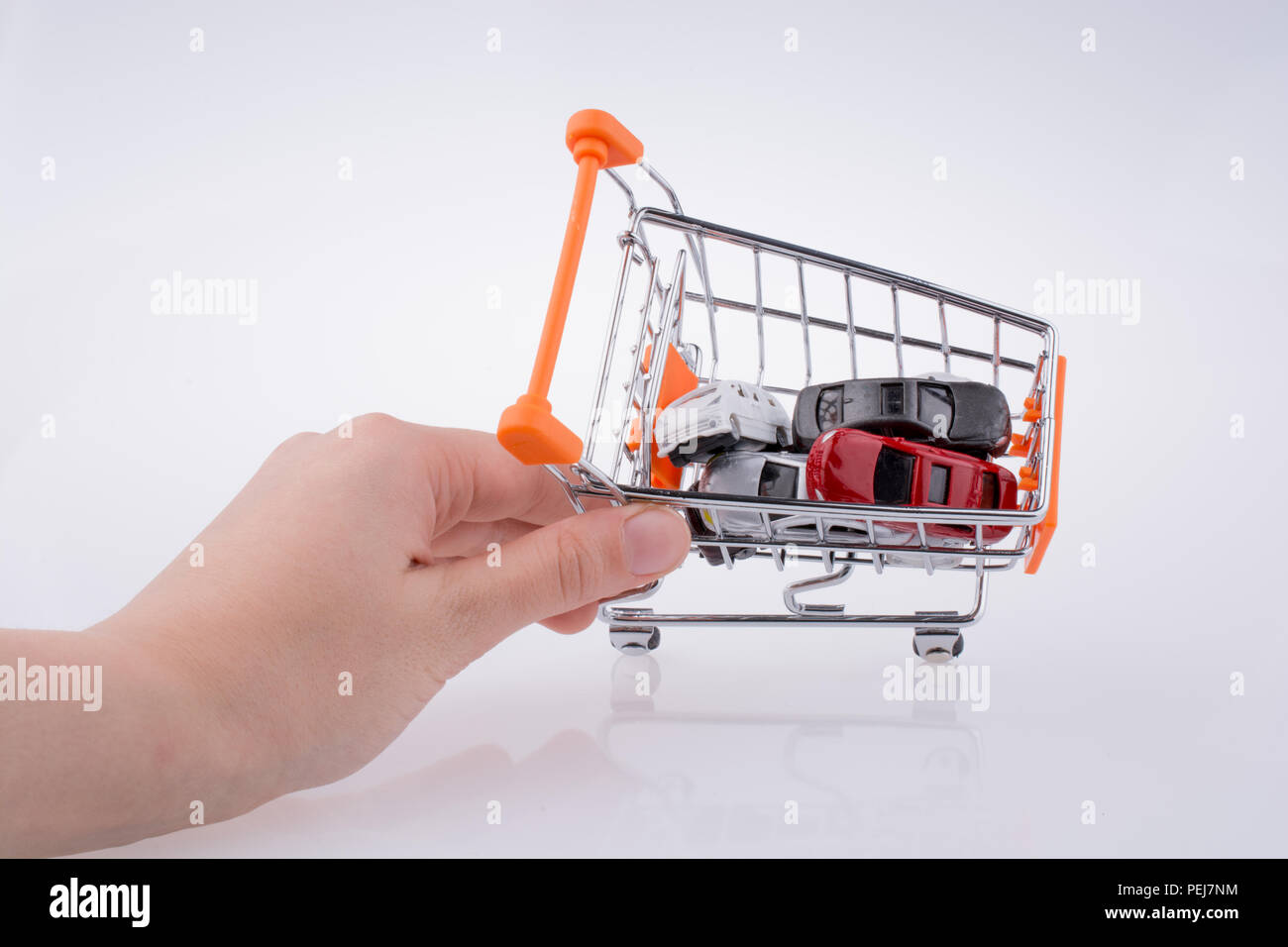 Cars near a shopping cart on a white background Stock Photo - Alamy